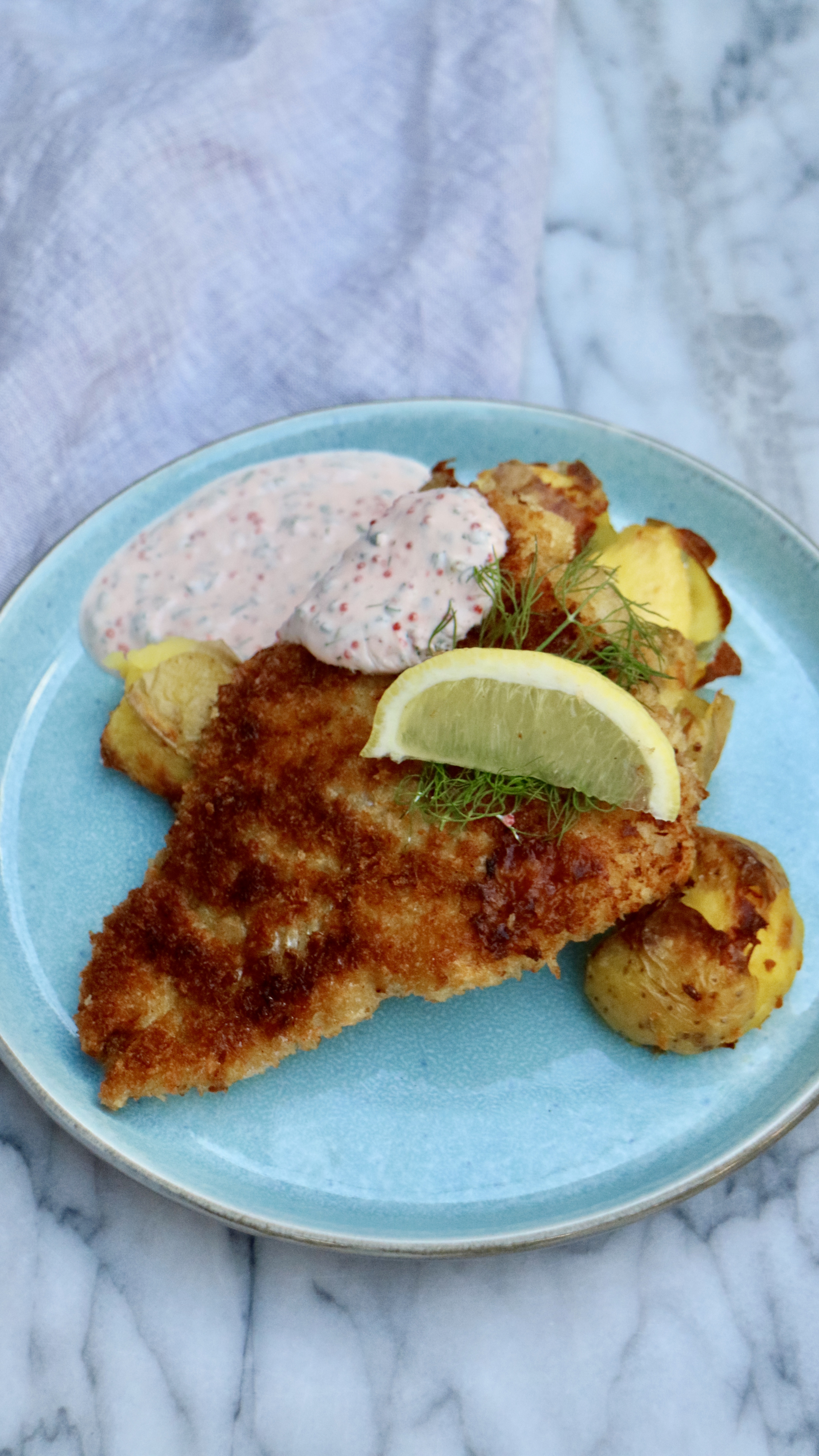 Fried cod with crispy smashed potatoes and creamy caviar sauce ...